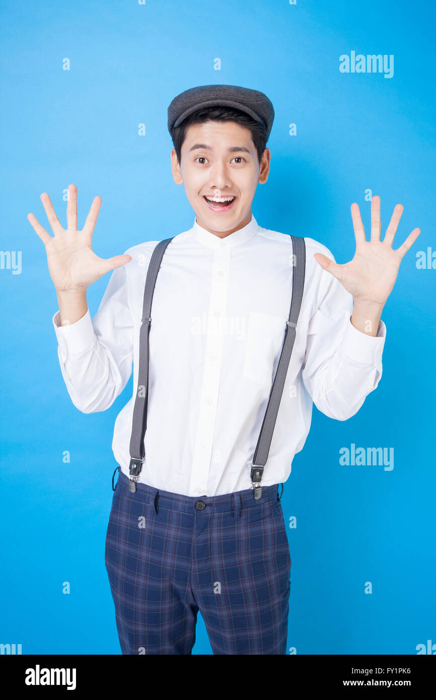 Young smiling man in retro style showing hands staring at front Stock ...