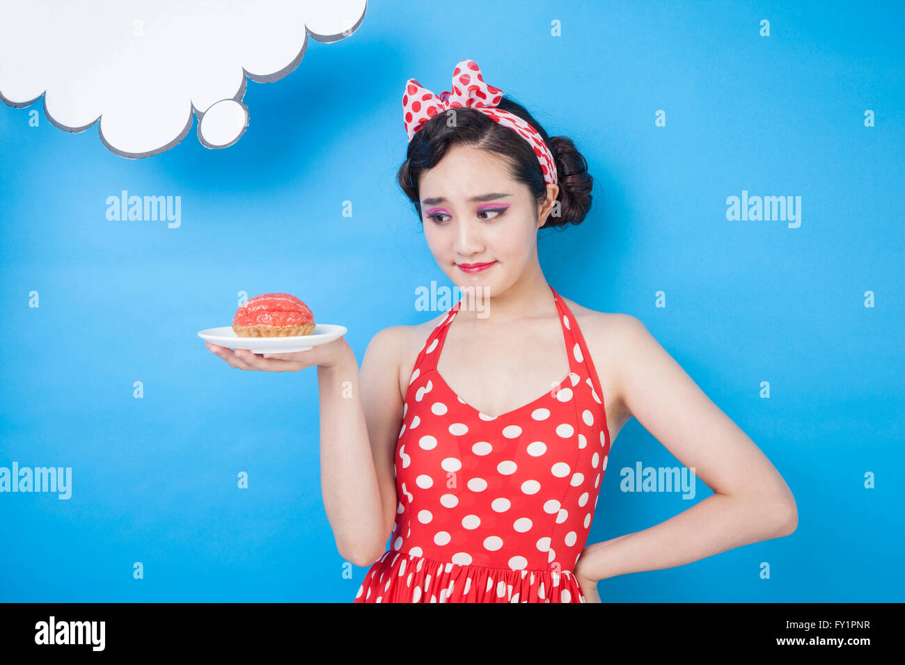 Portrait of young woman with a frown on her face in retro style posing ...