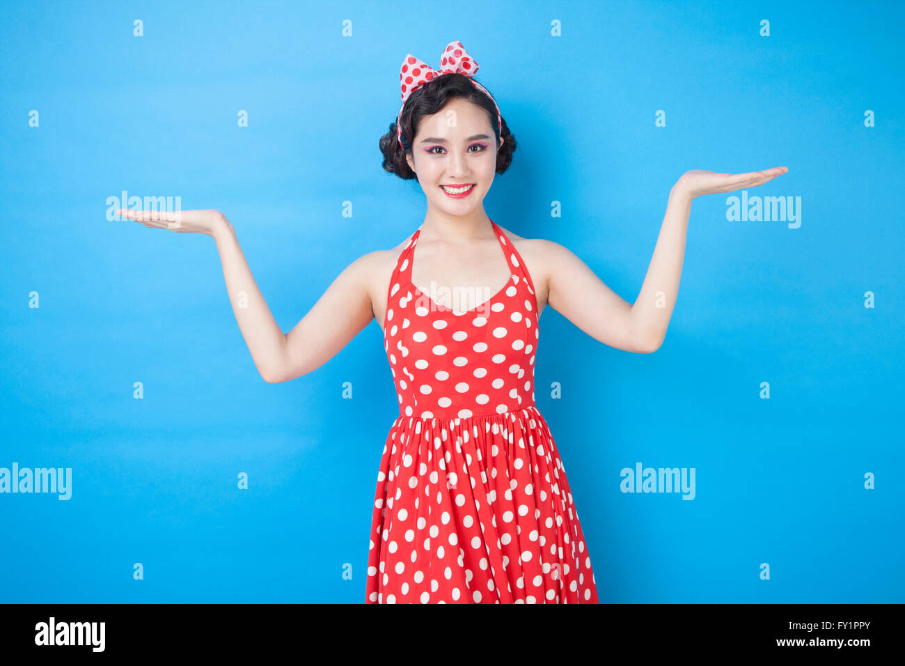 Young smiling woman in retro style holding arms staring at front Stock ...