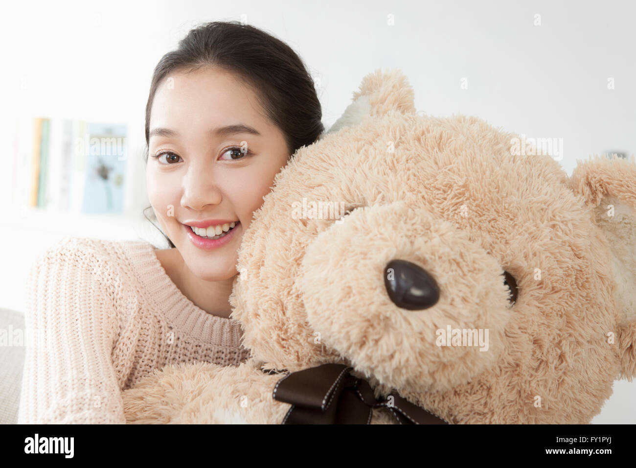 Portrait of young smiling woman with a big teddy bear Stock Photo - Alamy