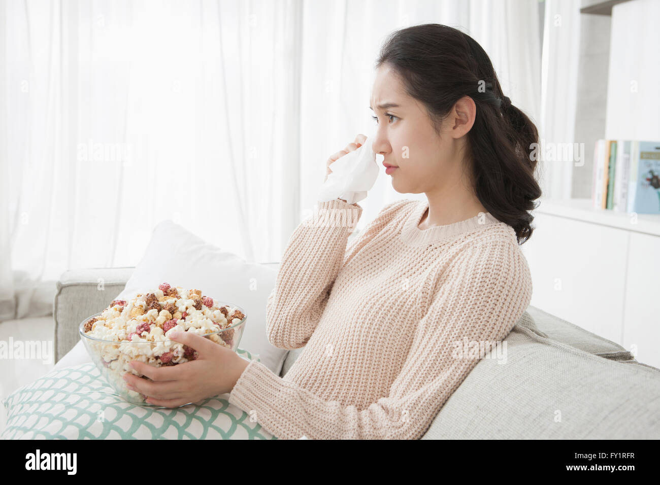 Side view portrait of young woman wiping her tears Stock Photo - Alamy