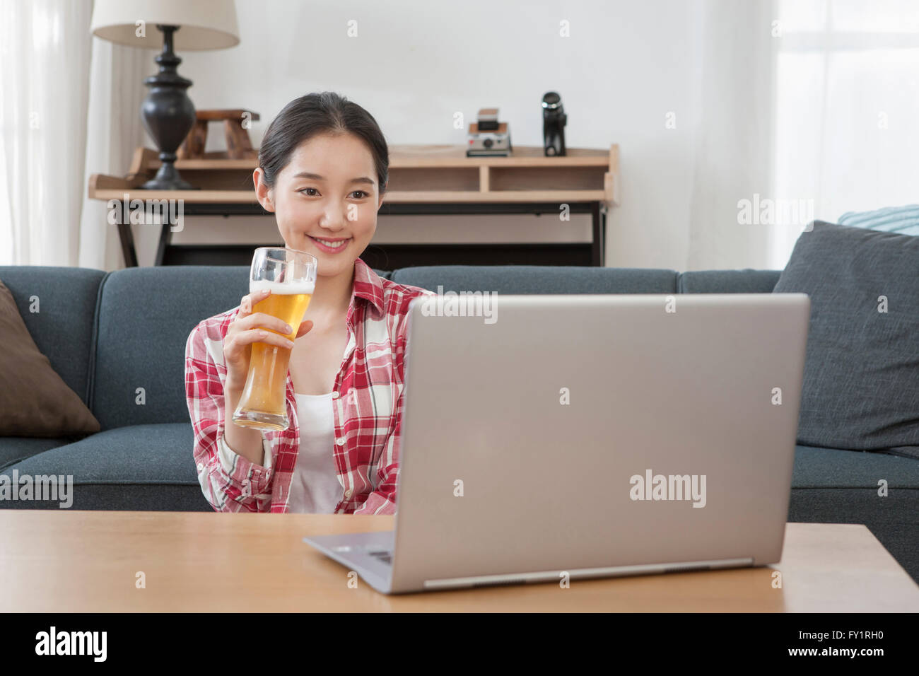 Woman holding up beer hi-res stock photography and images - Alamy
