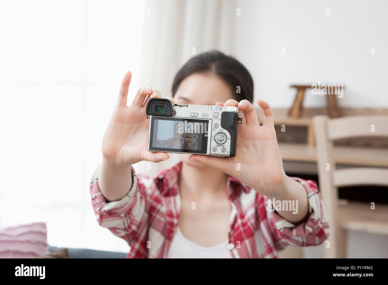 Portrait of young woman taking picture with digital camera Stock Photo ...
