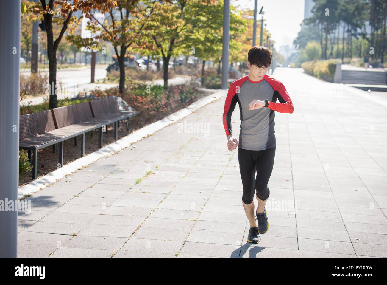 Man running watch park hi-res stock photography and images - Alamy