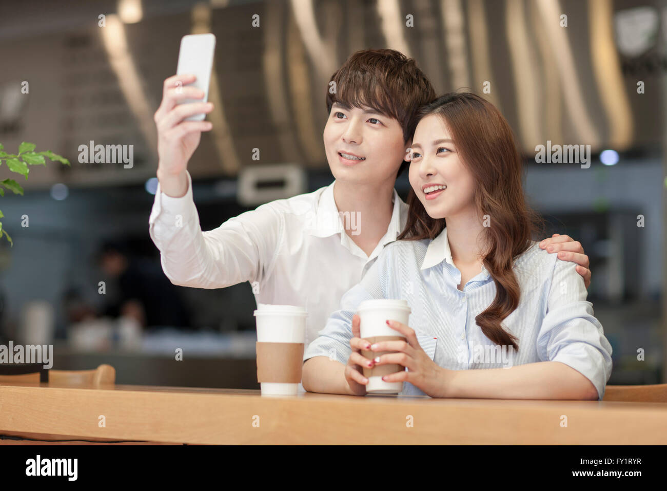 Portrait of yo smiling couple taking picture of themselves Stock Photo ...