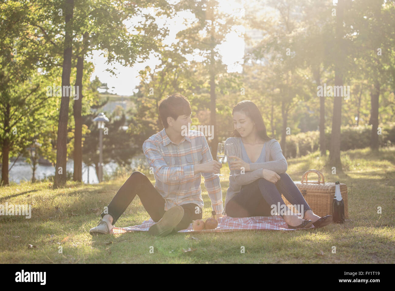 Young romantic couple having a picnic at park Stock Photo - Alamy