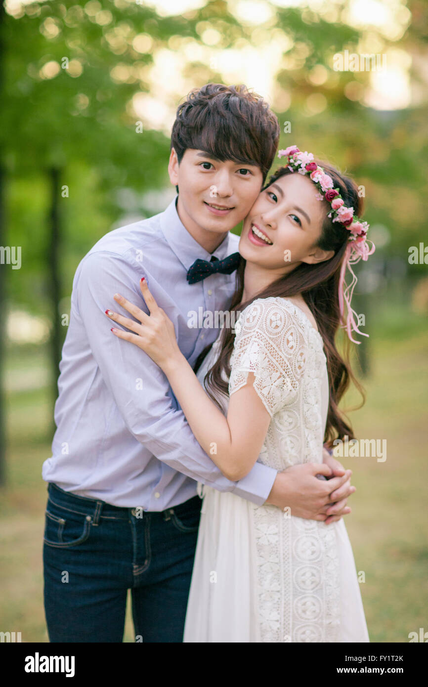 Romantic couple smiling hugging hi-res stock photography and images - Alamy