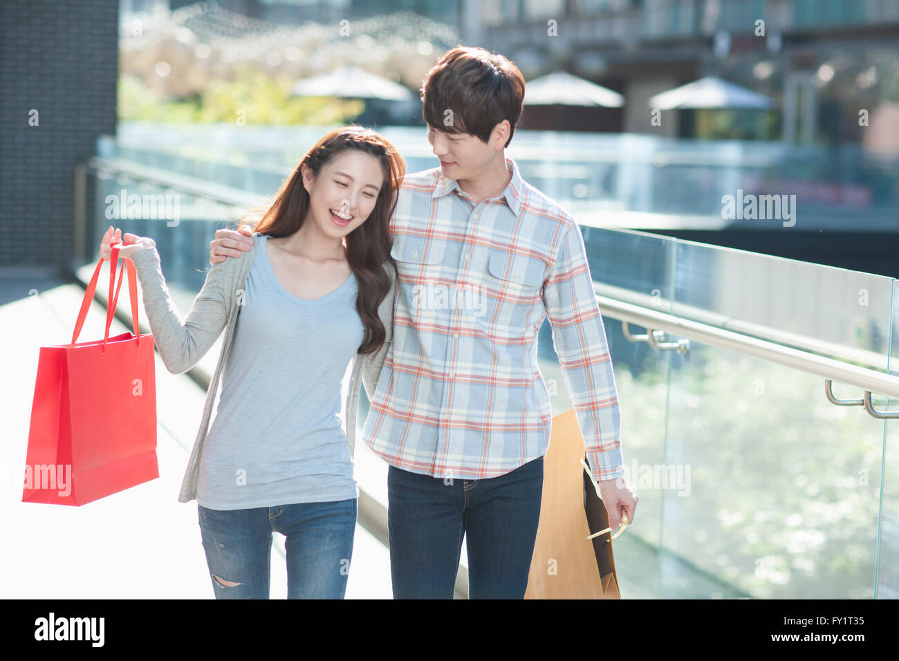 Young smiling couple having a date with shopping bags Stock Photo - Alamy