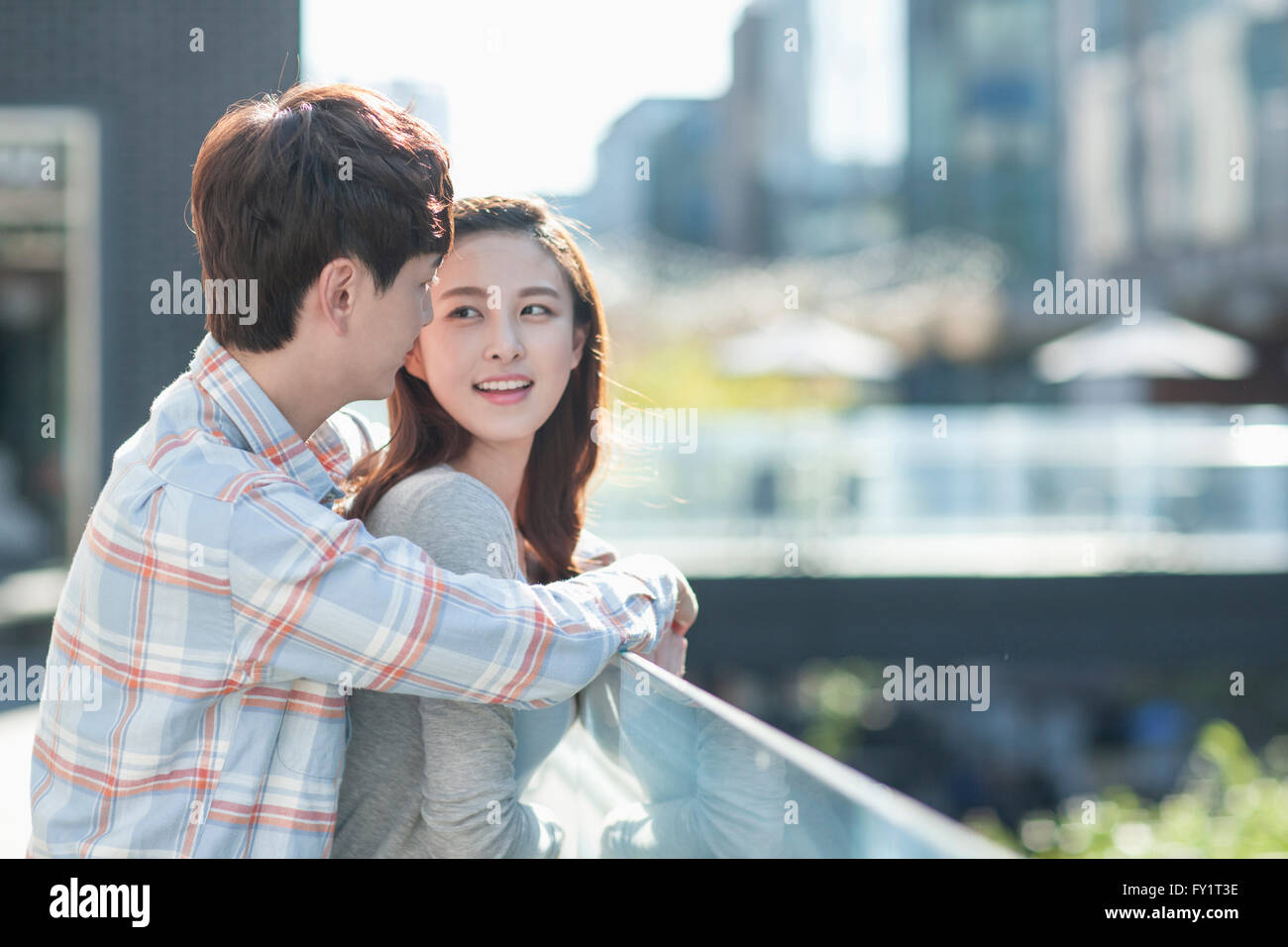 Side view portrait of young smiling couple hugging face to face Stock ...