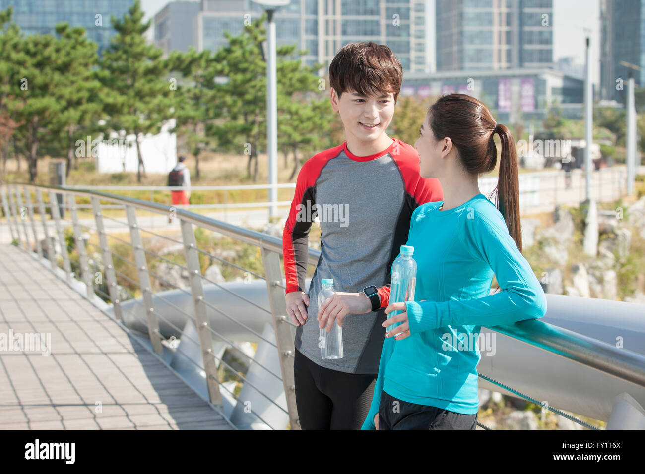 Side view portrait of young smiling couple resting face to face with ...