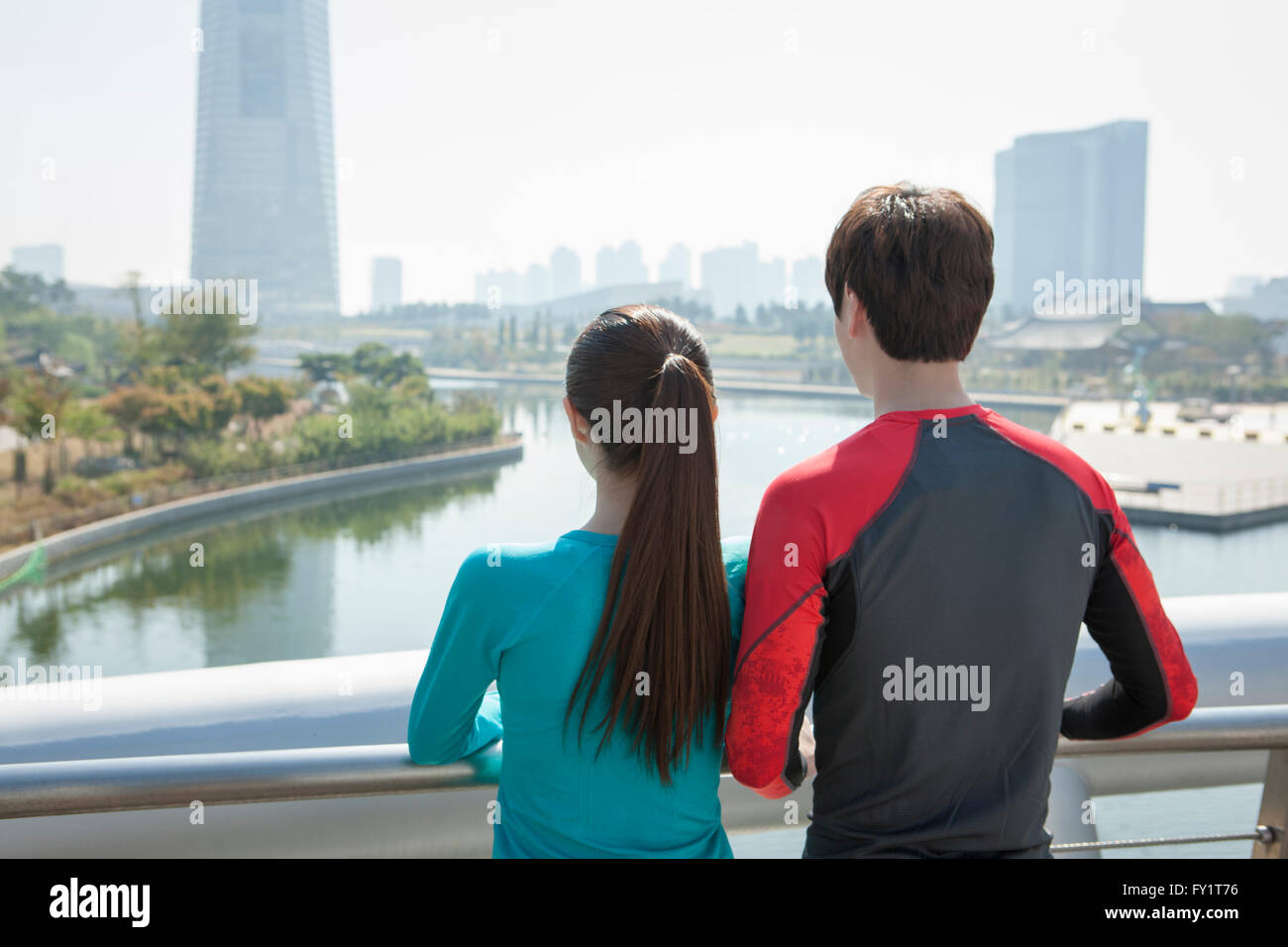 Back of young couple watching view of lake Stock Photo - Alamy