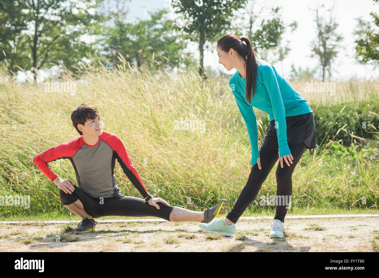Two young people stretching hi-res stock photography and images - Alamy