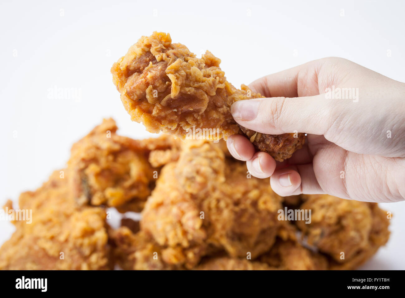 Hand with fried chicken Stock Photo - Alamy