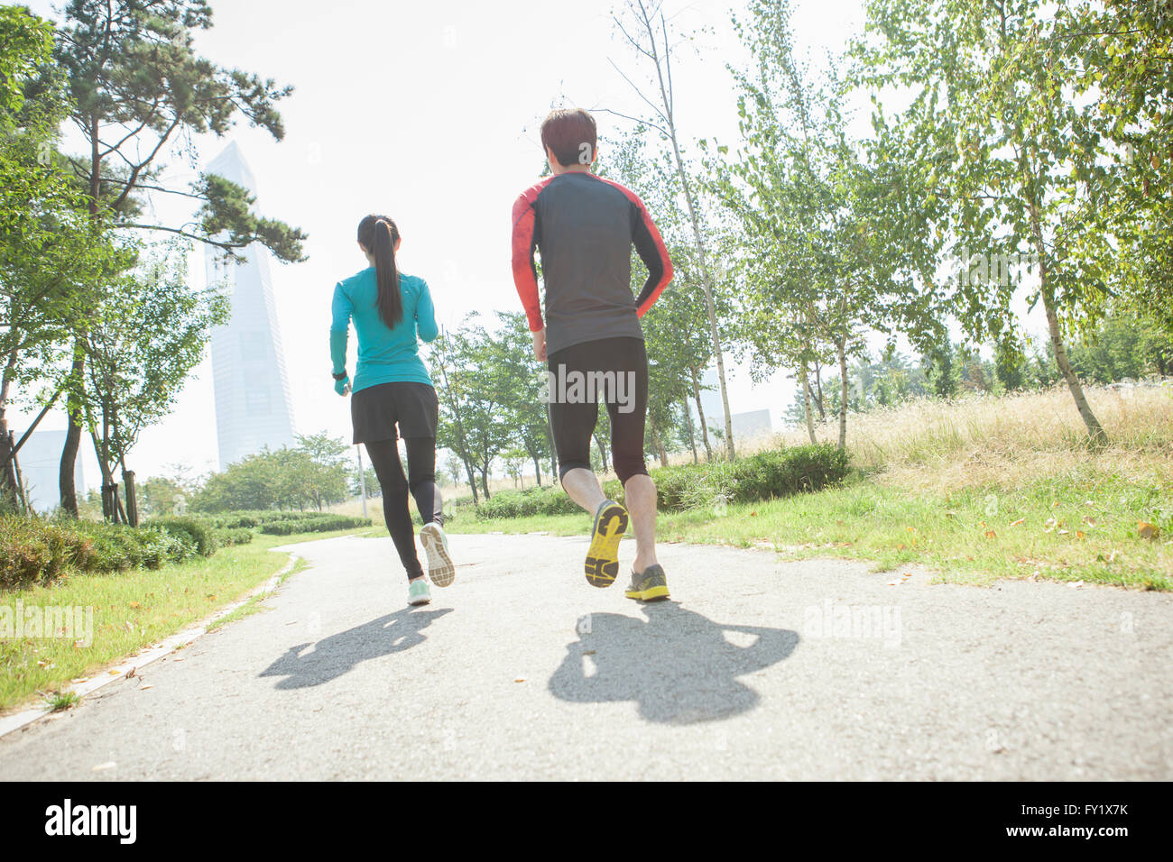 Back appearance of a couple in sports wear jogging at the park Stock ...