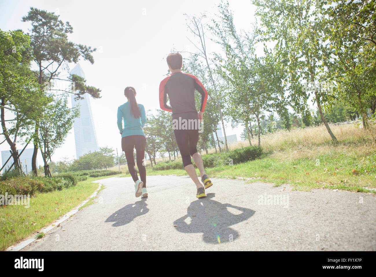Back appearance of a couple in sports wear jogging at the park Stock ...