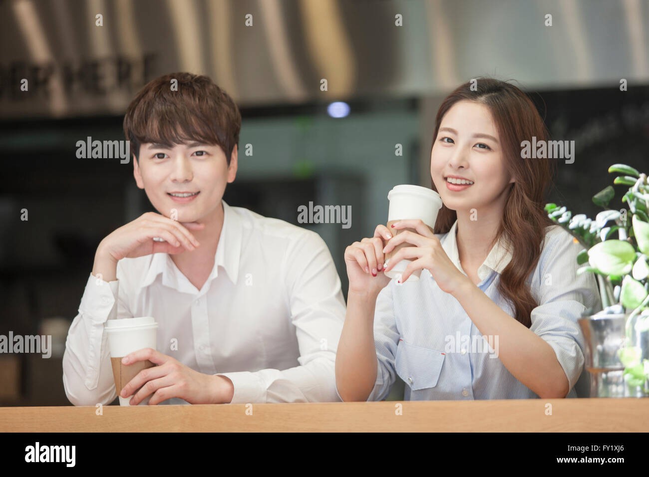 Couple having coffee time at cafe Stock Photo - Alamy