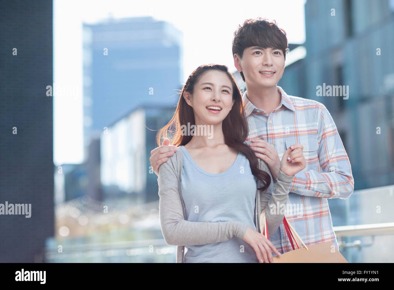 Couple staring forward with a smile outside Stock Photo - Alamy