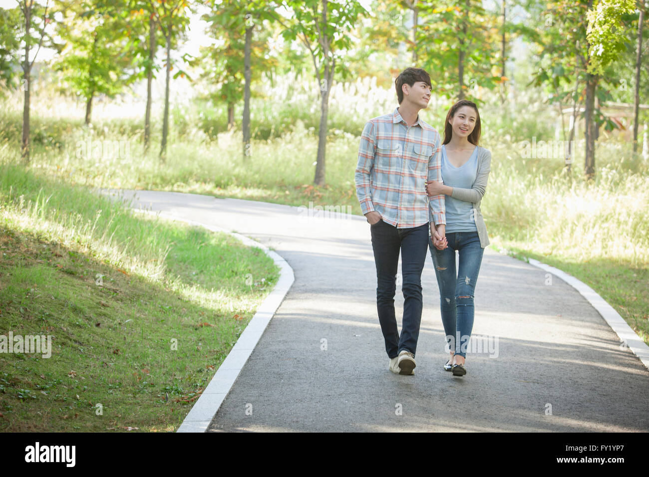 Couple talking a walk together at the park Stock Photo - Alamy