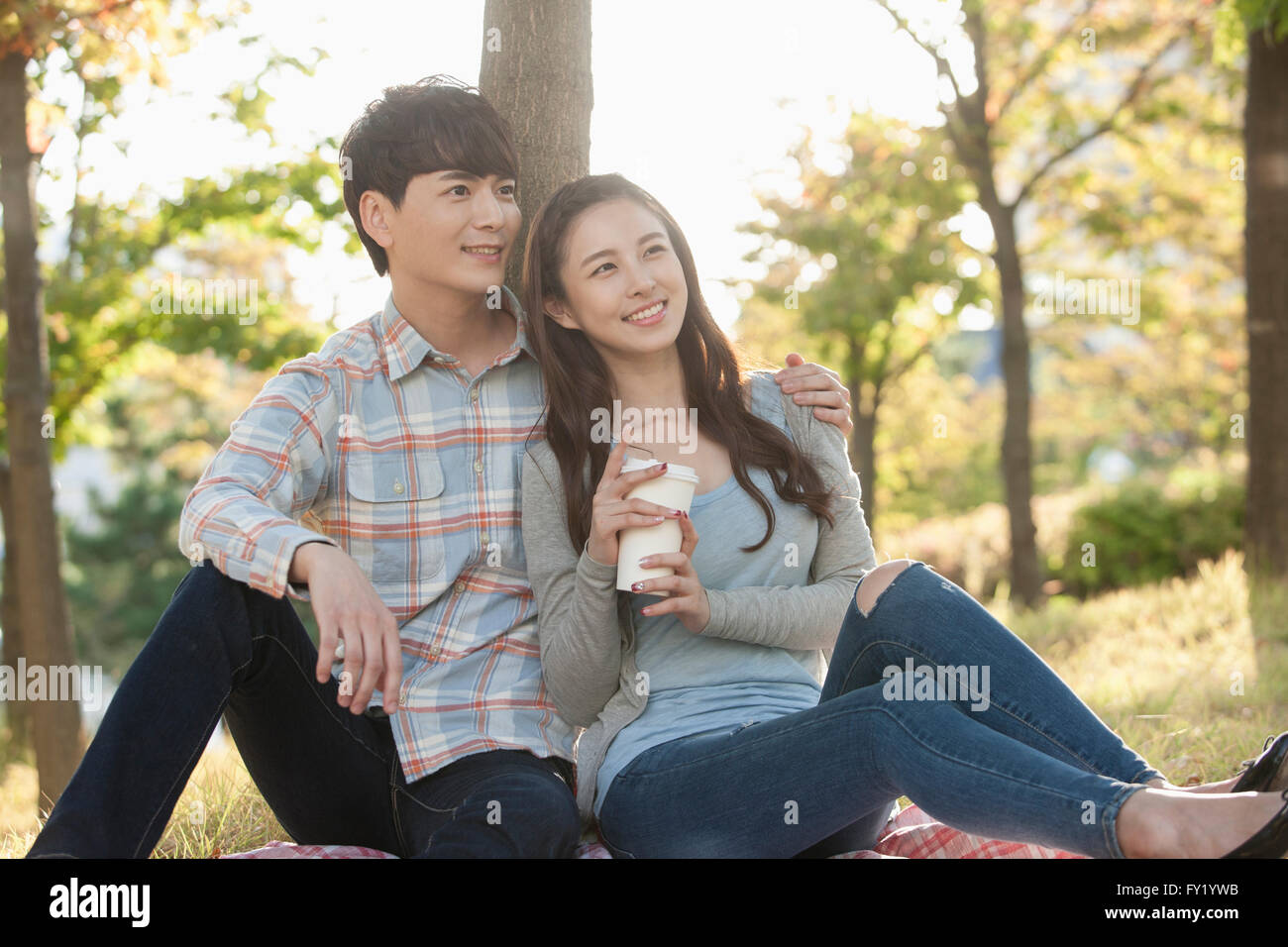 Couple having coffee time together at park Stock Photo - Alamy