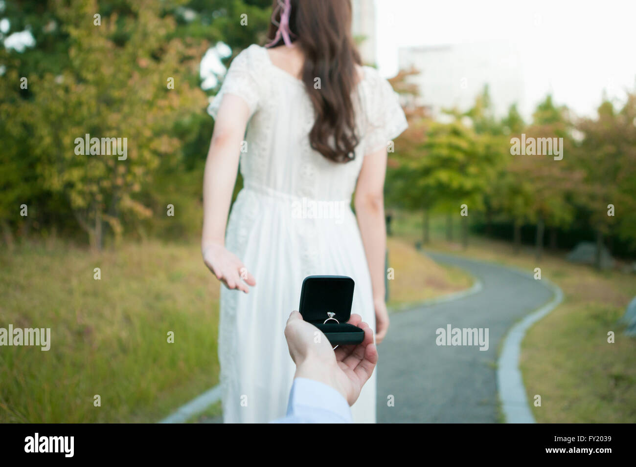 Man's hand giving a ring to a bride Stock Photo - Alamy