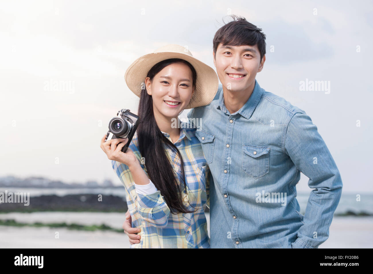 Couple staring forward with a smile at the beach Stock Photo - Alamy