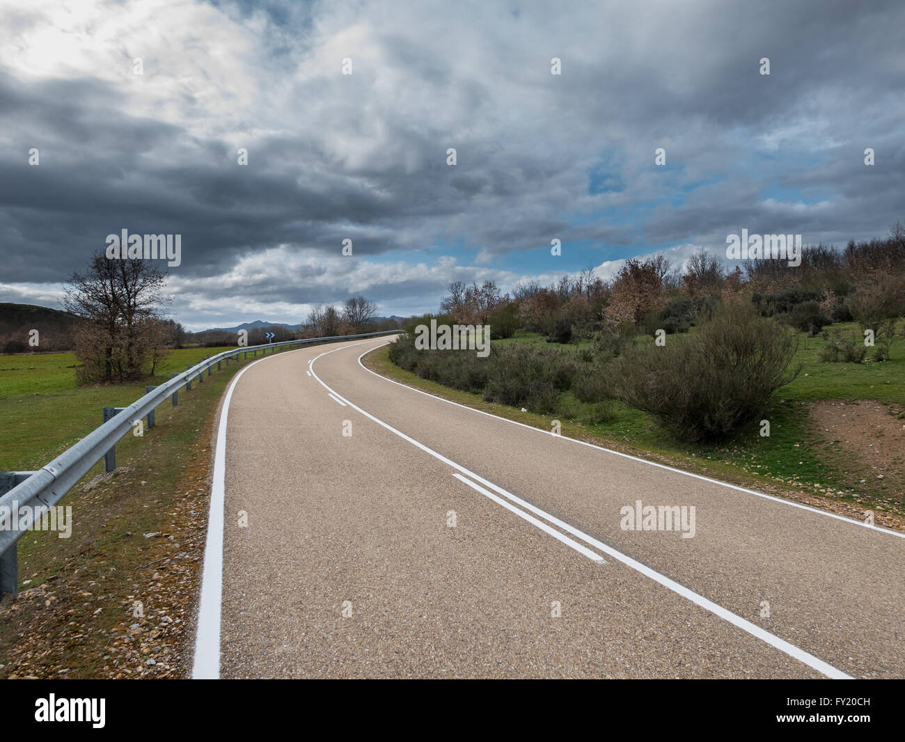 Road starting right handed curve Stock Photo - Alamy