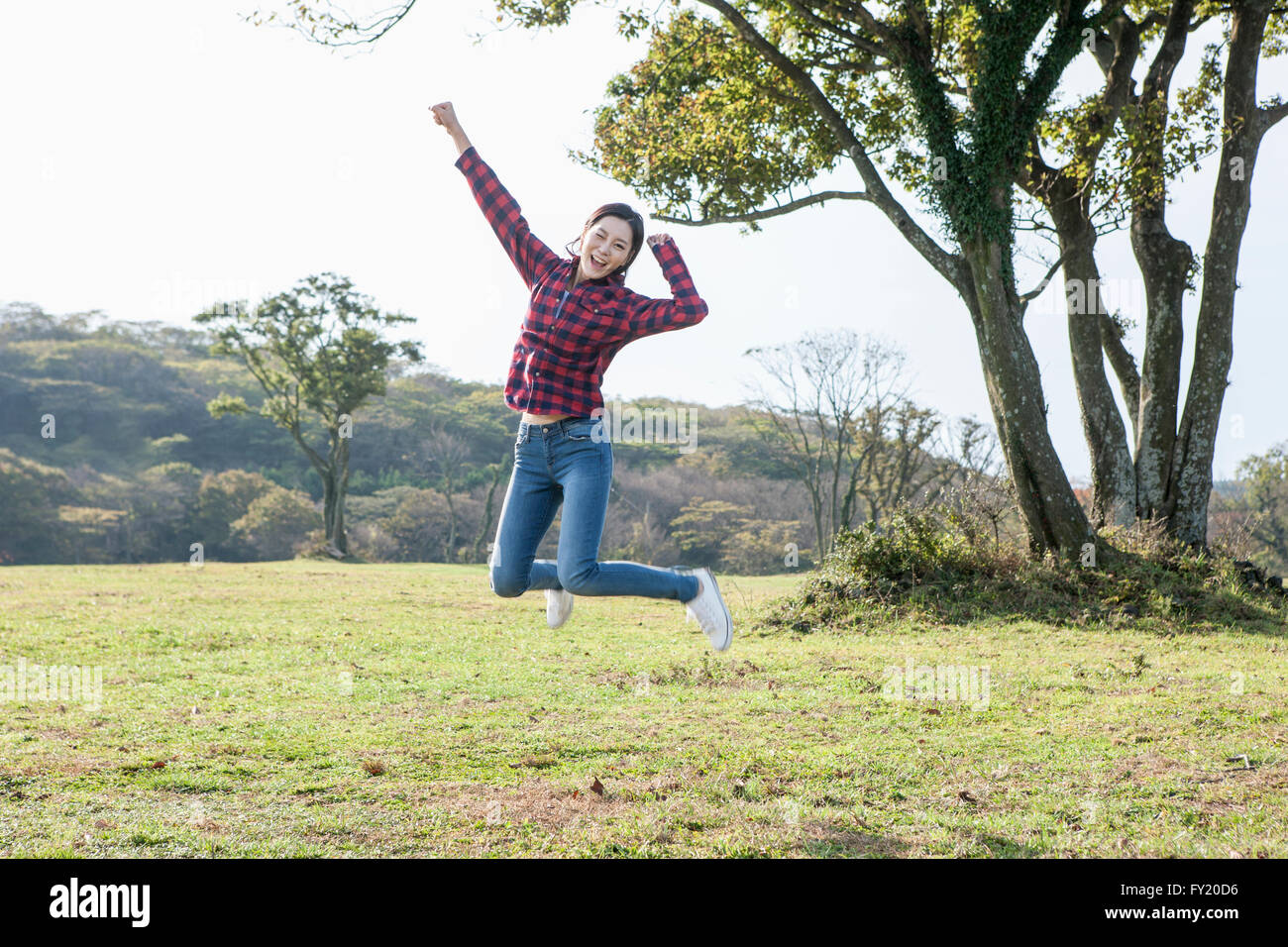Woman jumping high at the field Stock Photo - Alamy