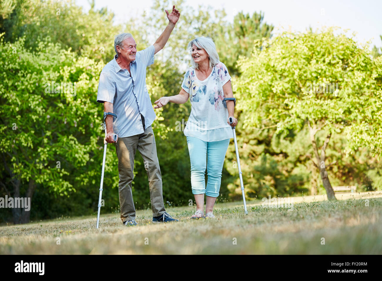 Happy senior couple on crutches having fun in the park in summer Stock ...