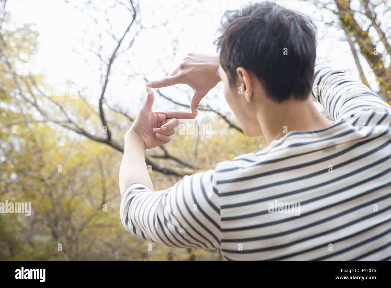 Man making a frame with his hand and looking through it Stock Photo - Alamy