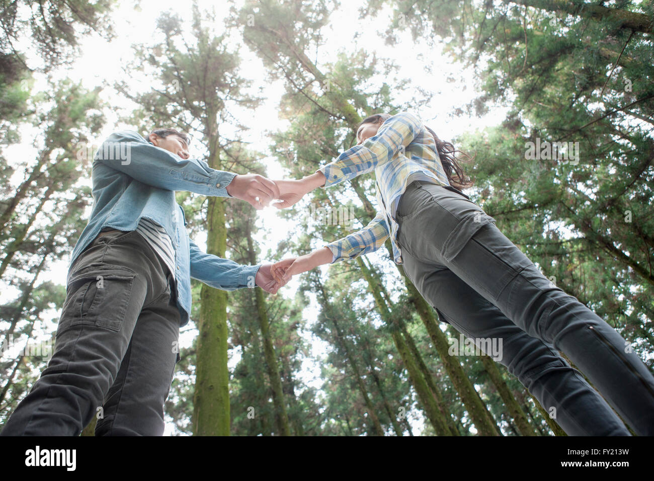 Low angle of a couple holding hands together Stock Photo - Alamy