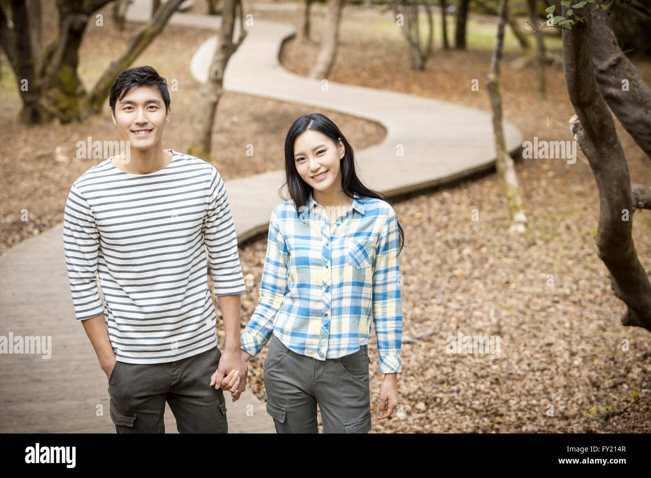 Couple taking a walk together in woods Stock Photo - Alamy