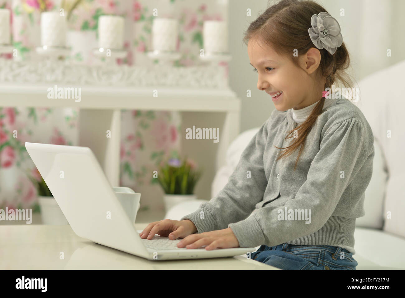 smiling little girl with laptop computer Stock Photo - Alamy