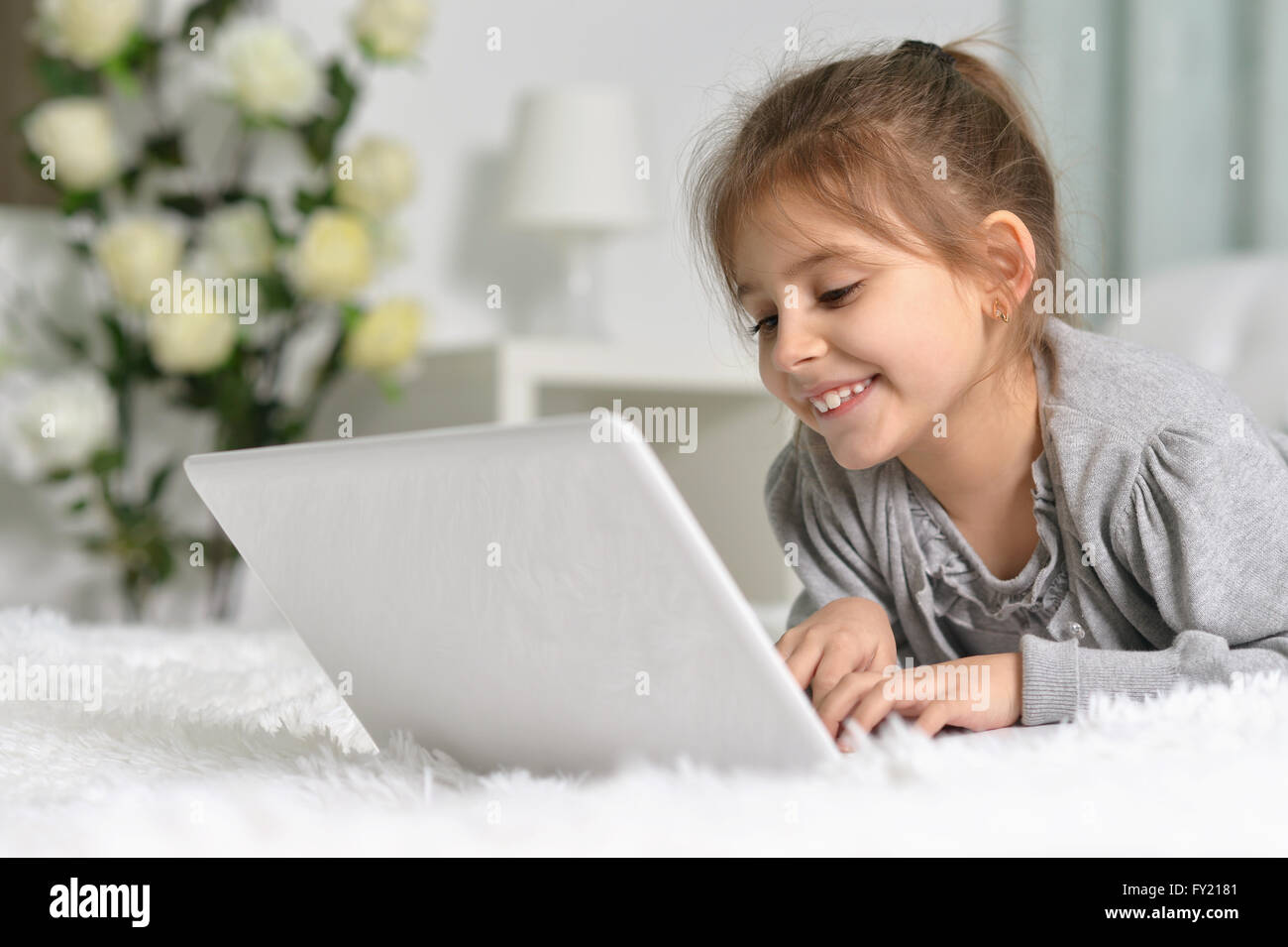 Cute little girl with laptop Stock Photo - Alamy
