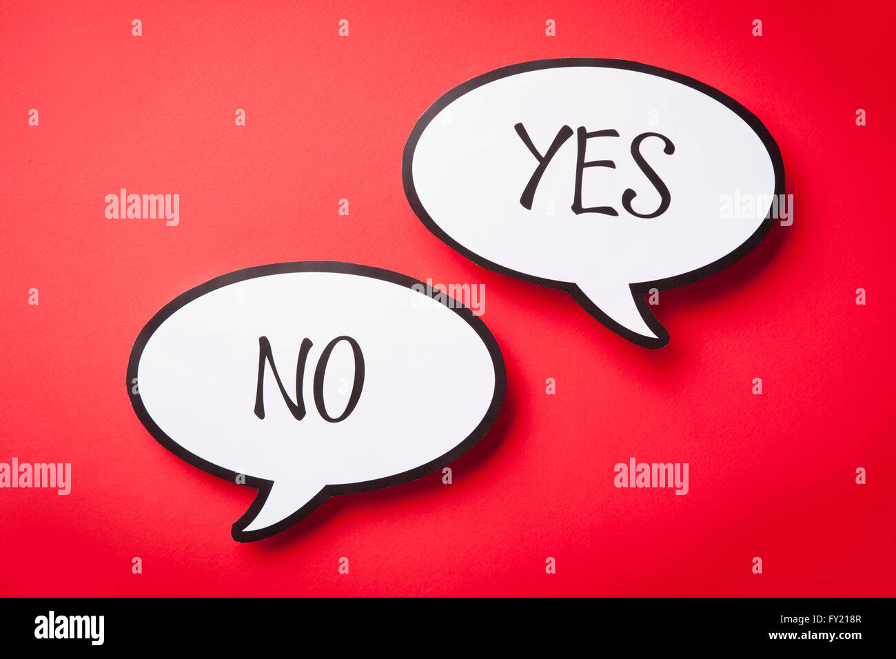 Yes and No sign in speech balloons on red background Stock Photo - Alamy