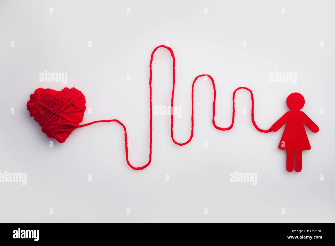 Red thread connecting heart and a woman sign representing life Stock ...