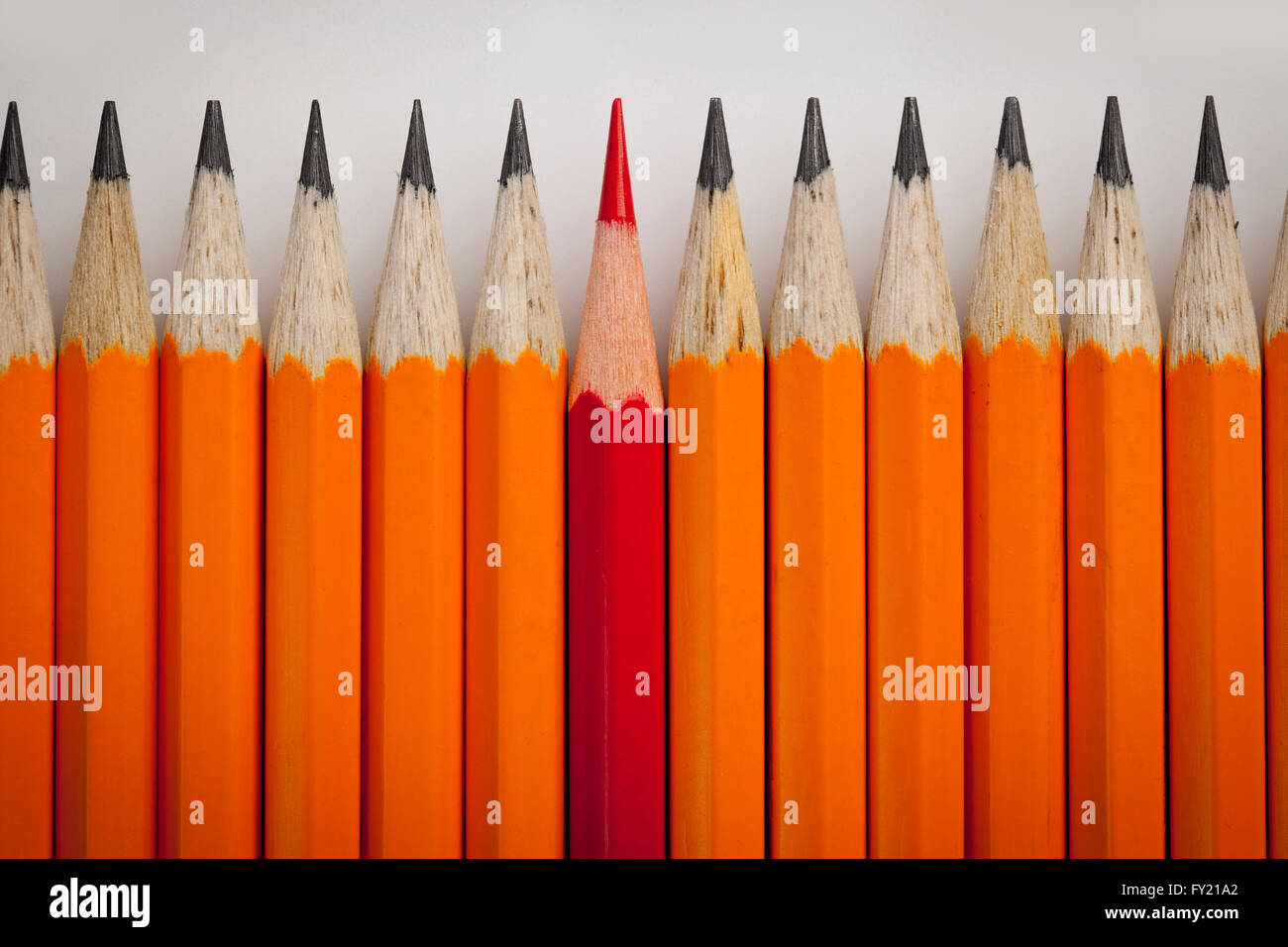 Red pencil in the middle of normal pencils Stock Photo - Alamy