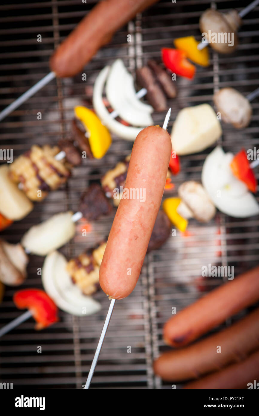 High angle of sausage on skewer being cooked Stock Photo - Alamy
