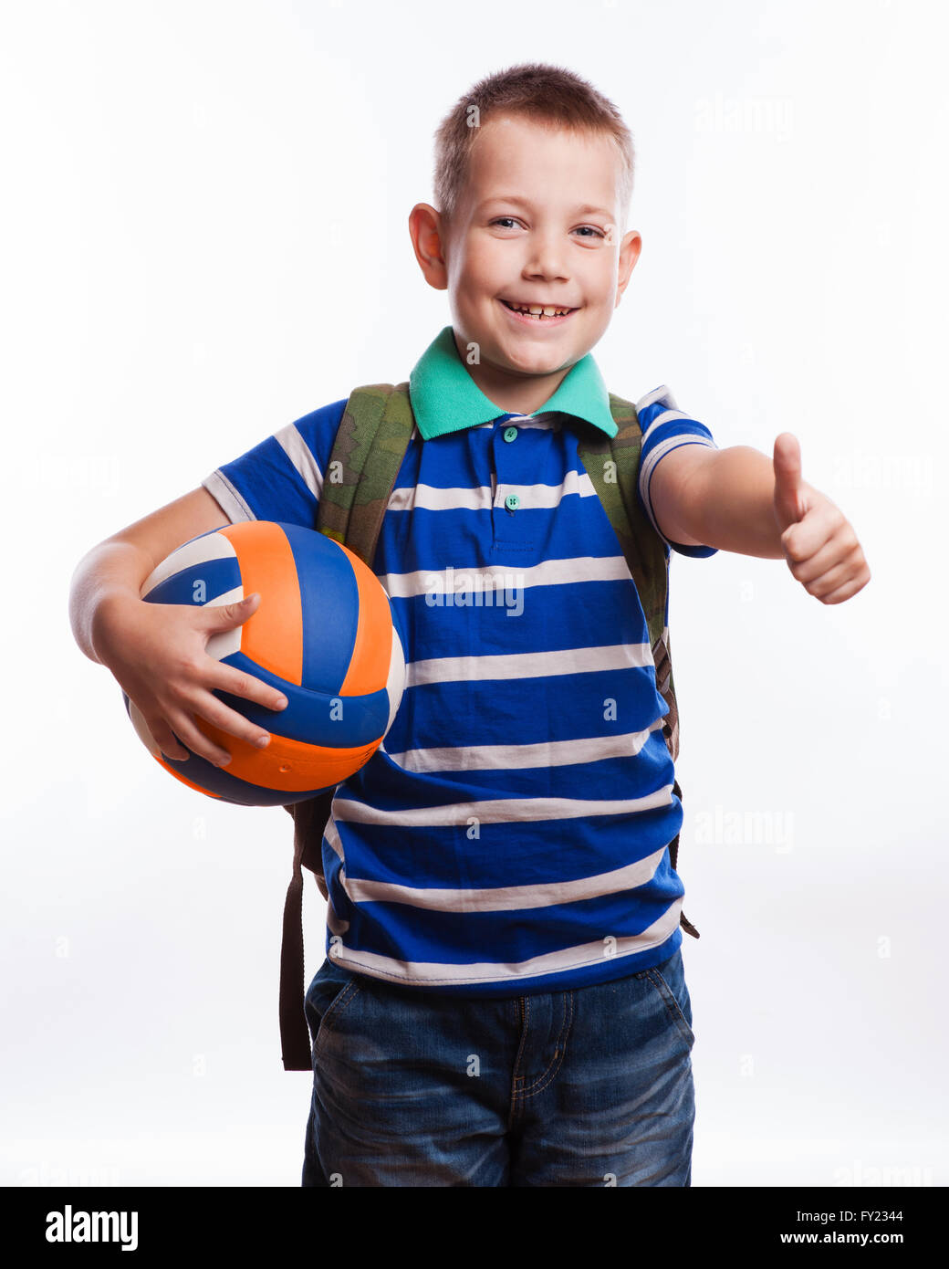 Happy schoolboy with backpack and soccer ball isolated on white ...
