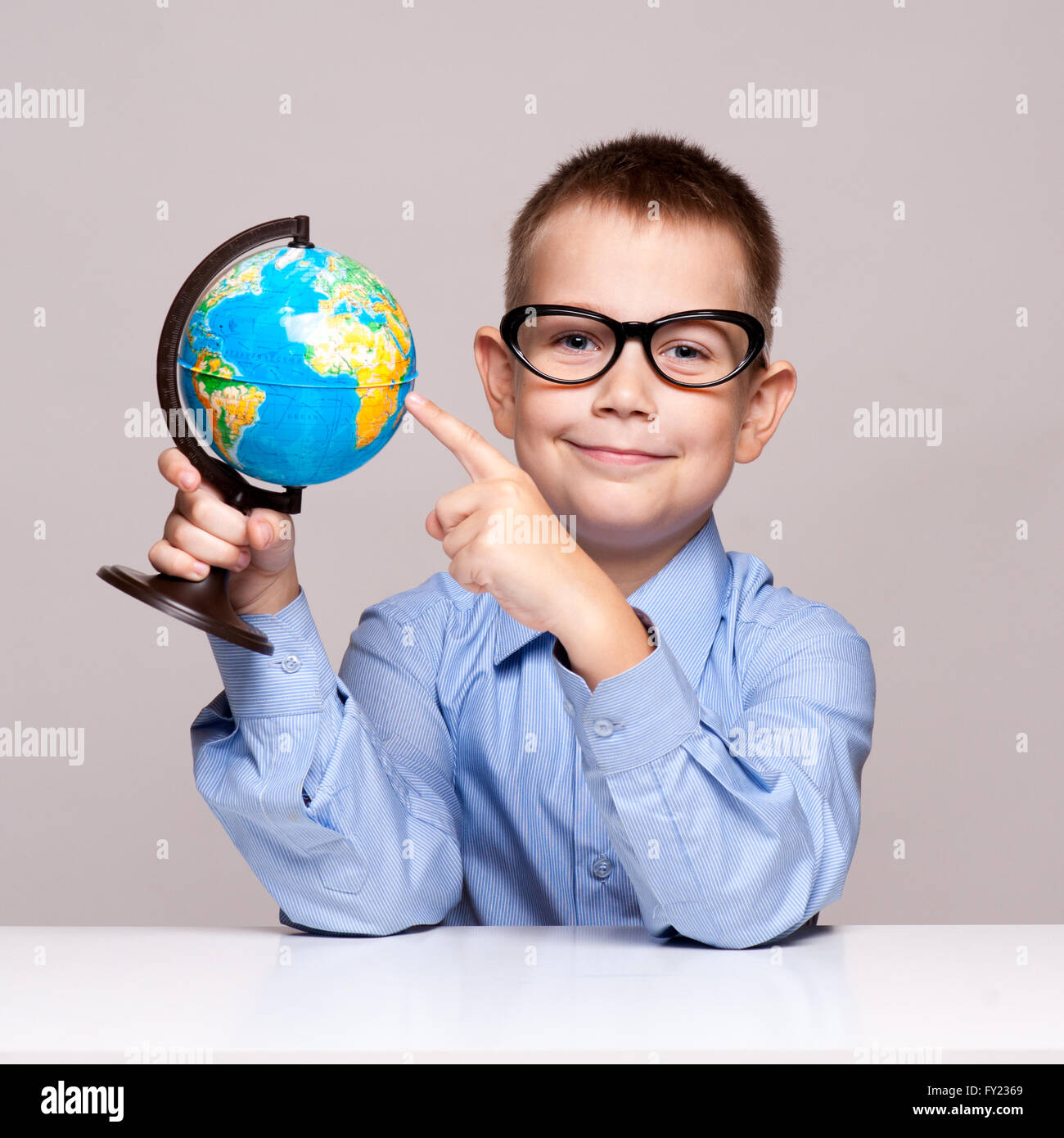 Portrait of a little boy holding a globe. Travel concept Stock Photo ...