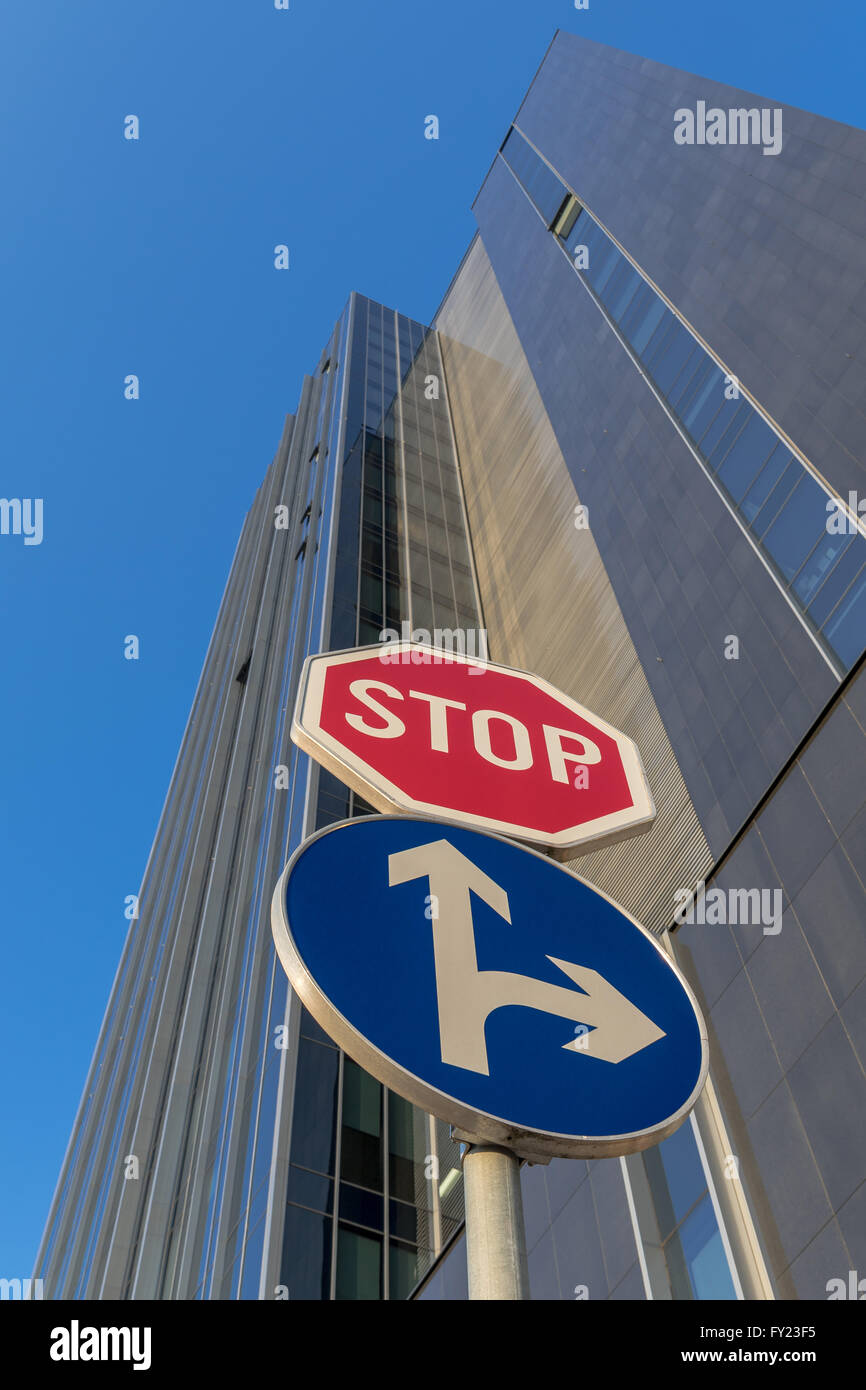 Stop sign with office building in the background Stock Photo - Alamy