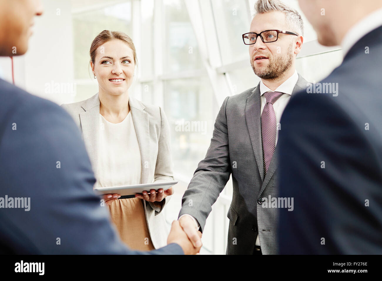 Handshaking happy business people meeting hi-res stock photography and ...