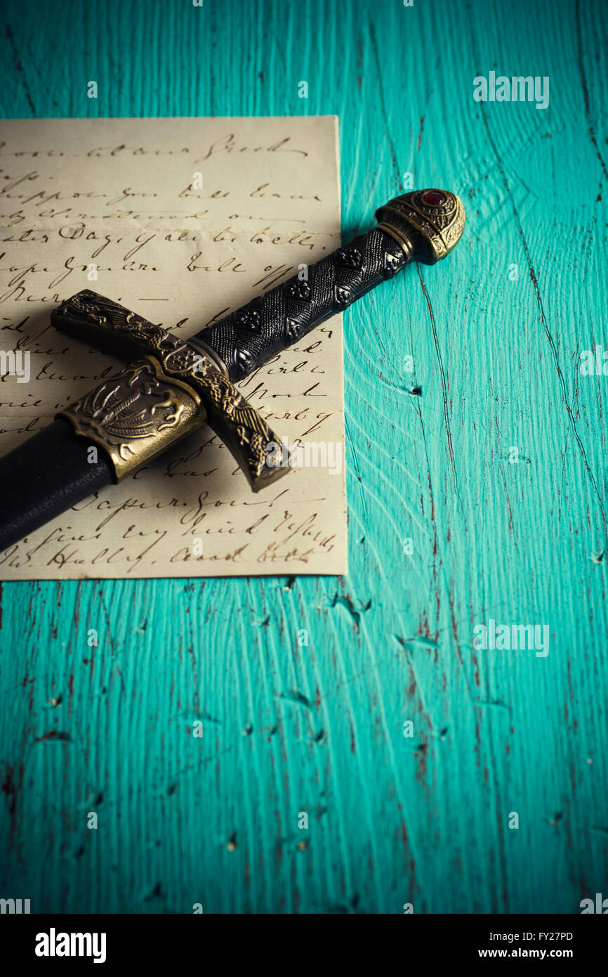 Historic dagger with an old letter Stock Photo - Alamy
