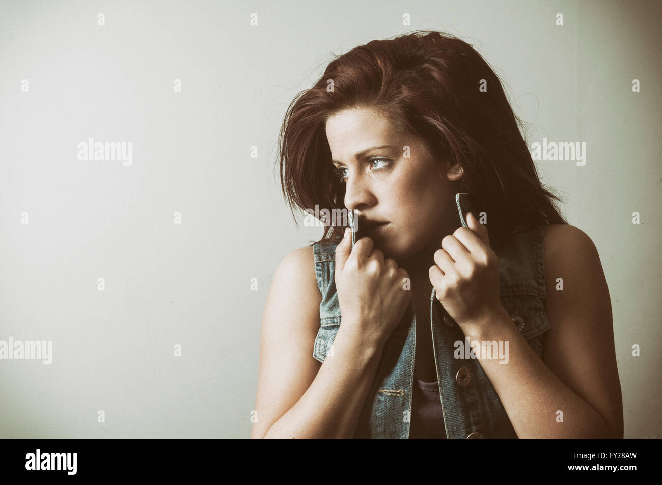 Scared young woman looking away Stock Photo - Alamy