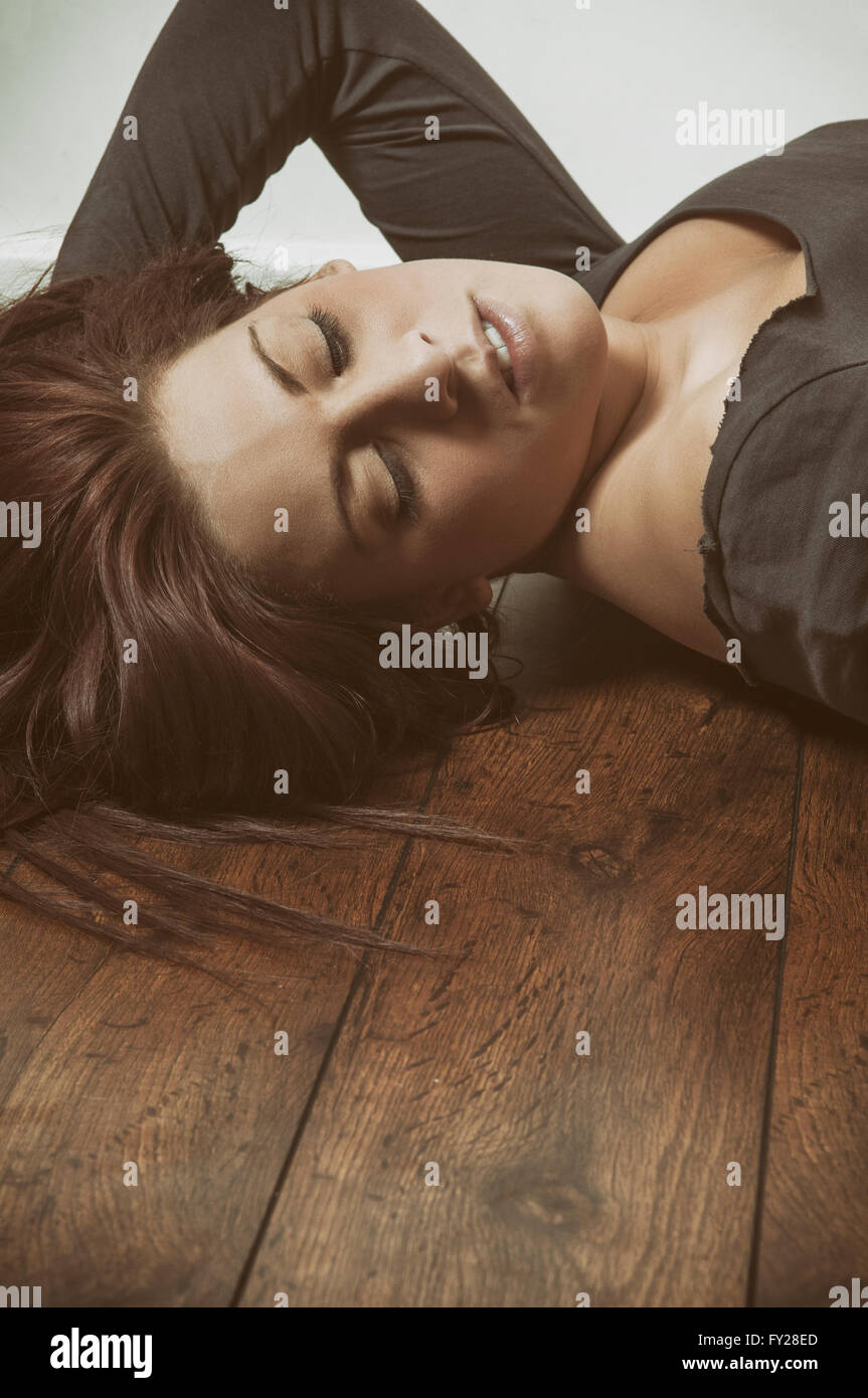 Stressed woman laying on the floor Stock Photo - Alamy