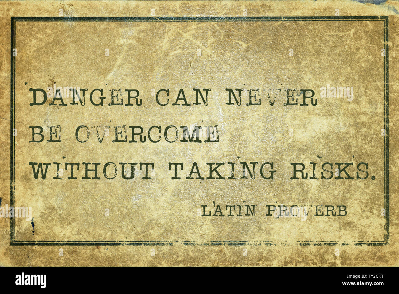 Danger can never be overcome - ancient Latin proverb printed on grunge ...