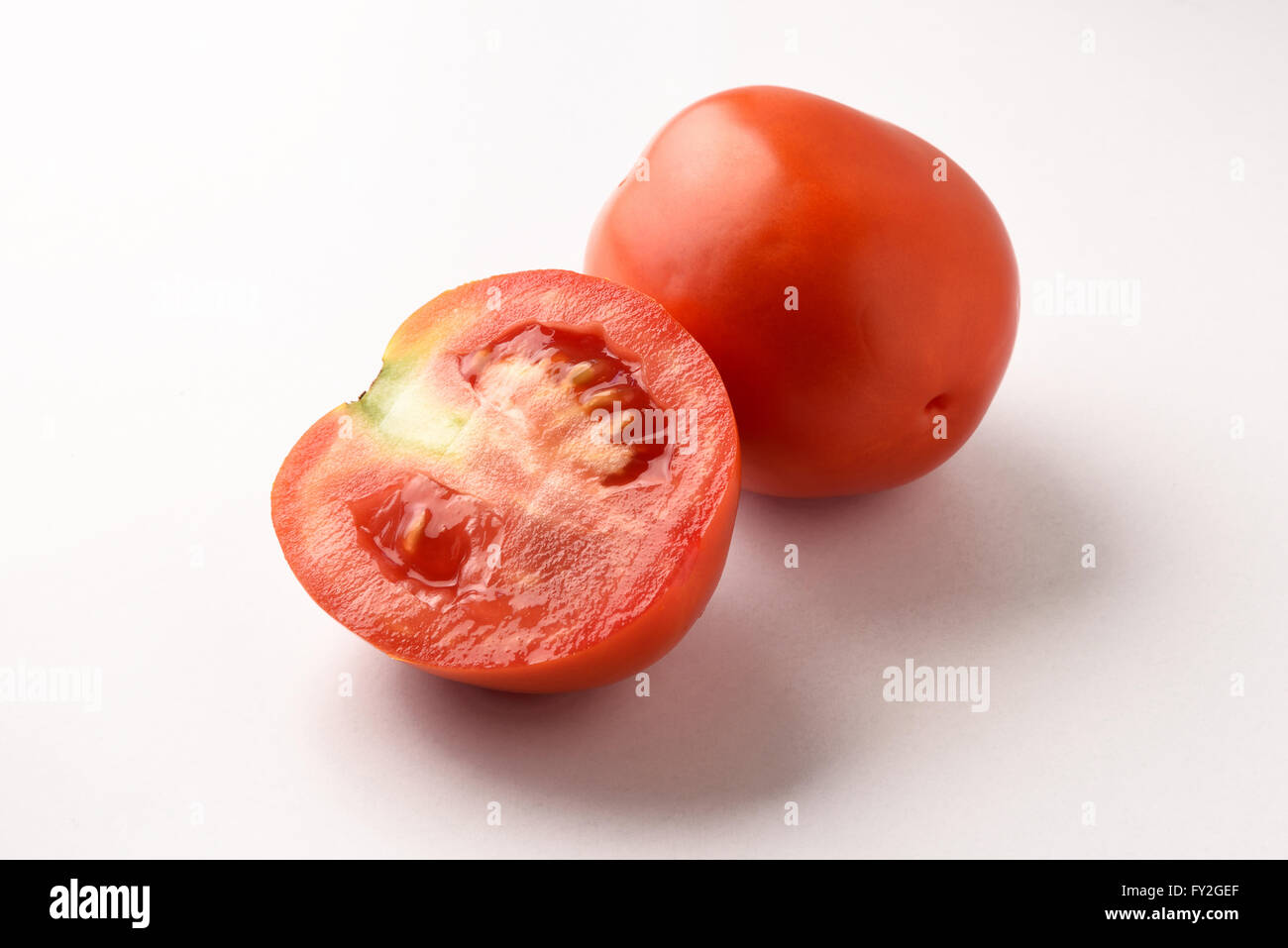 Fresh cut tomato isolated Stock Photo - Alamy