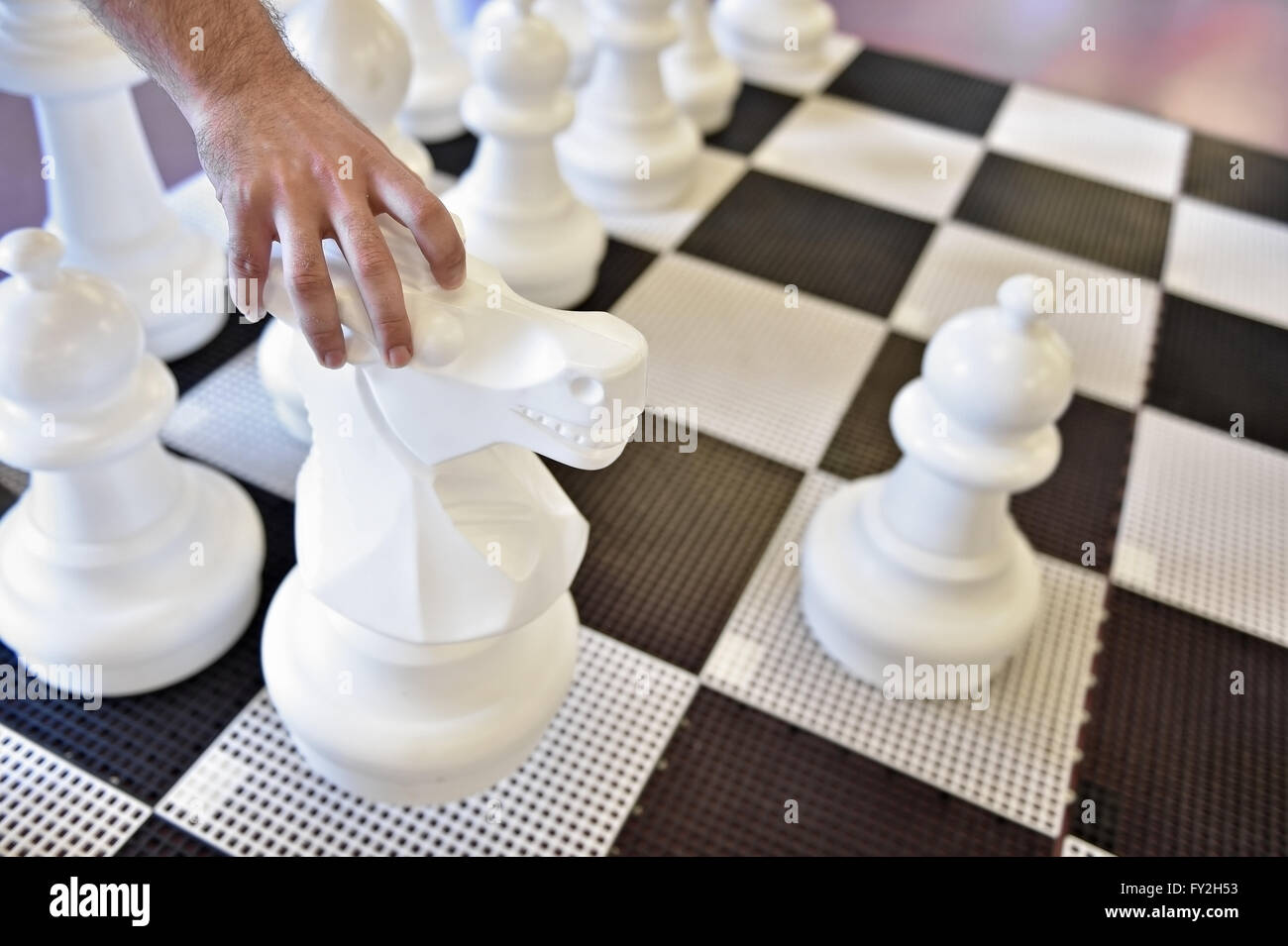 Hand moving the black pawn on a giant chess game Stock Photo - Alamy