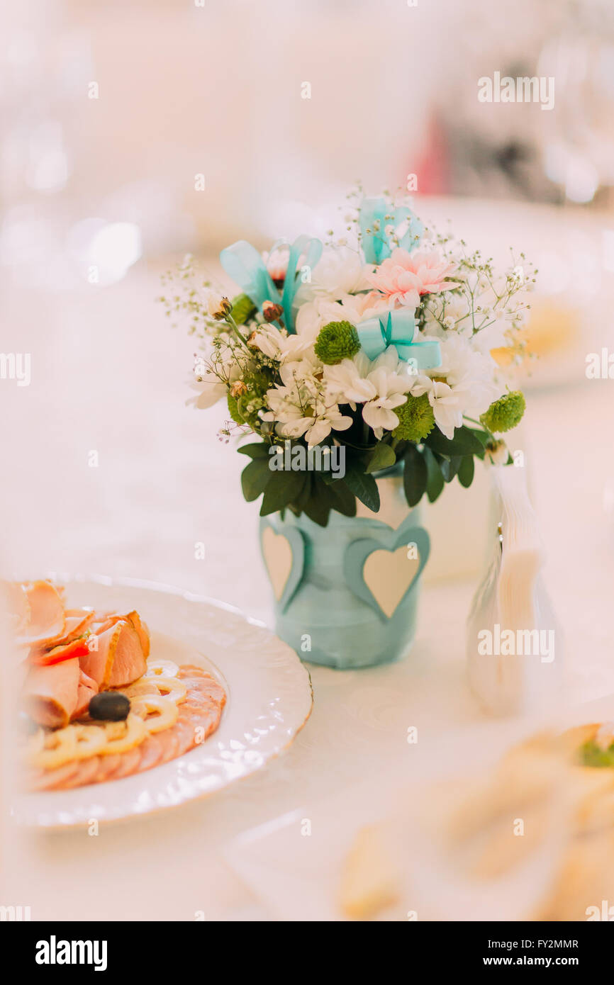 Fancy table setted for a wedding dinner and decorated with flowers in ...