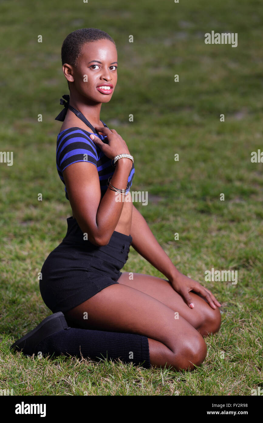 Woman in a sitting post lit with flash Stock Photo - Alamy