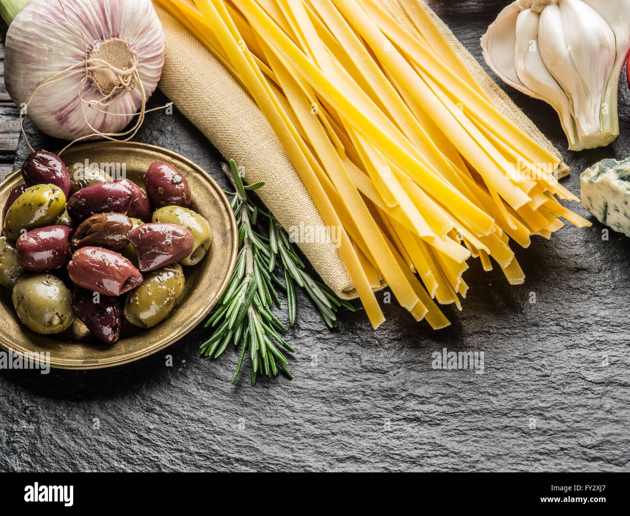 Pasta ingredients. Cherry-tomatoes, spaghetti pasta, rosemary and ...